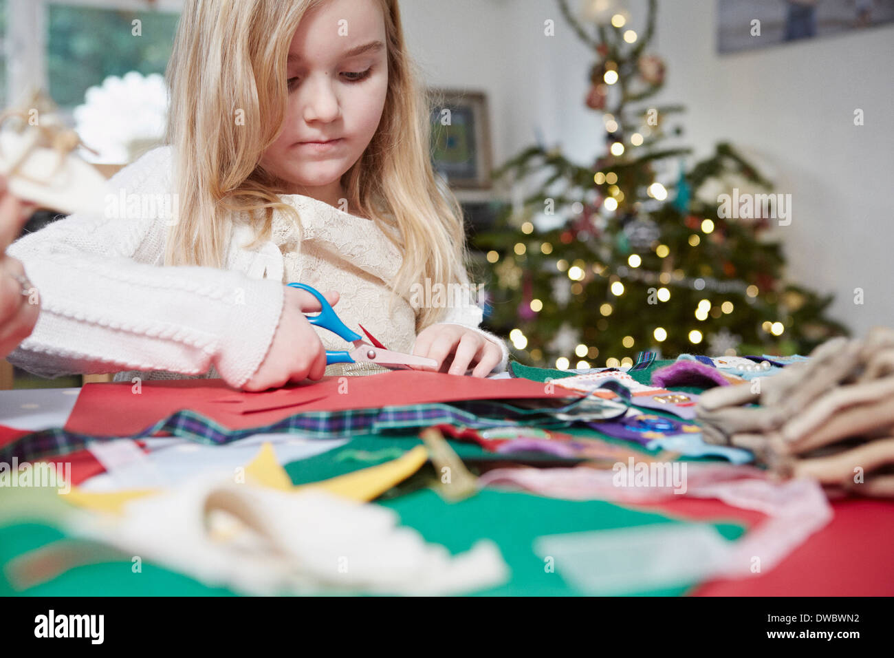 Young girl cutting out paper with scissors Stock Photo - Alamy