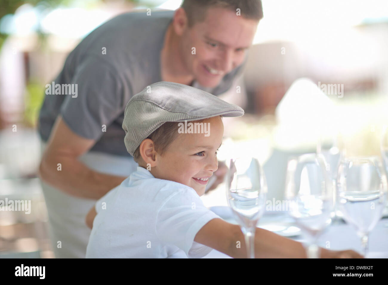 Father and son setting table Stock Photo - Alamy