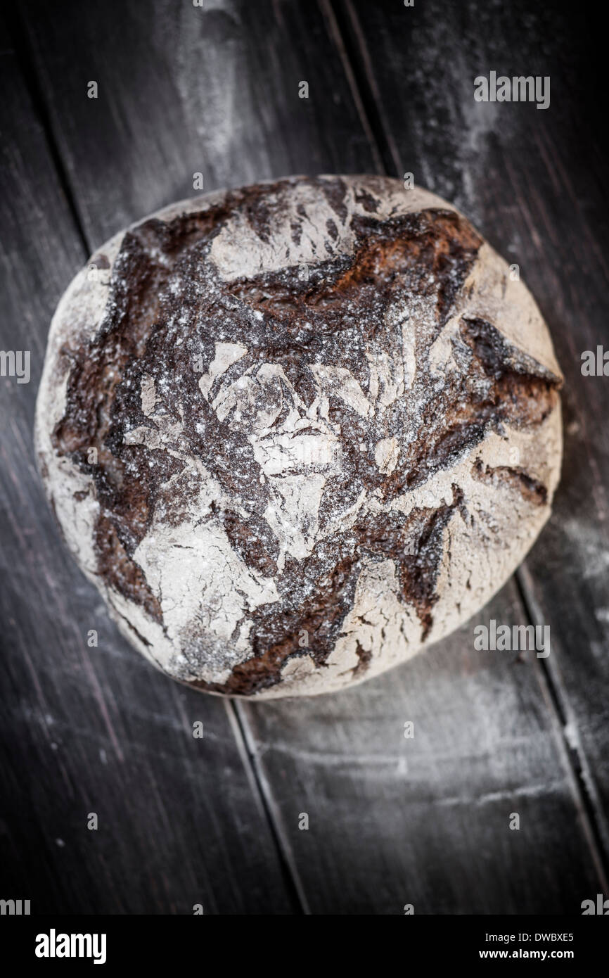 Rye-Spelt-Malt loaf and flour on wooden table Stock Photo - Alamy
