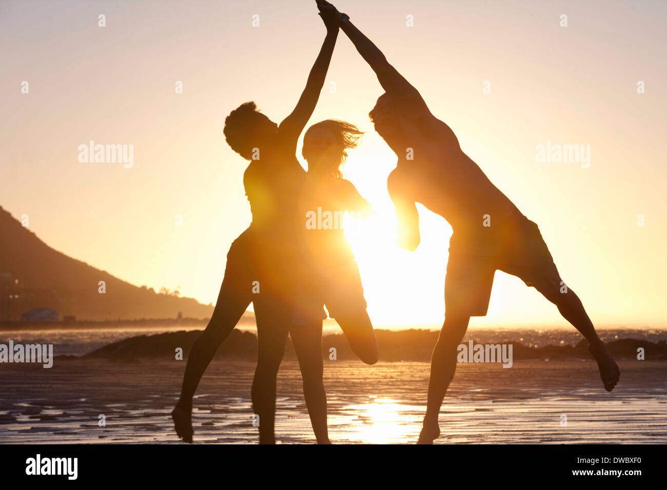 Friends jumping by seaside Stock Photo - Alamy