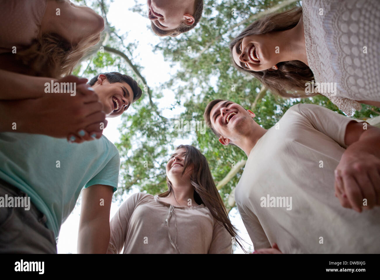 Friends forming circle Stock Photo - Alamy