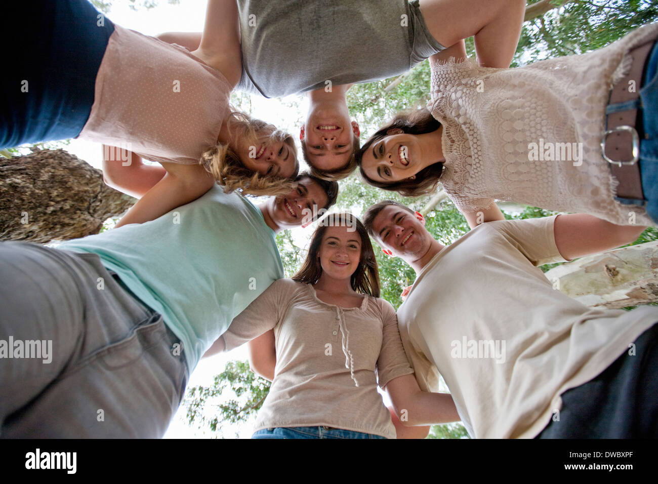 Friends forming circle Stock Photo - Alamy