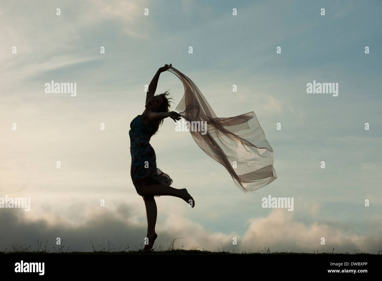 Woman dancing with sheer fabric over head Stock Photo - Alamy
