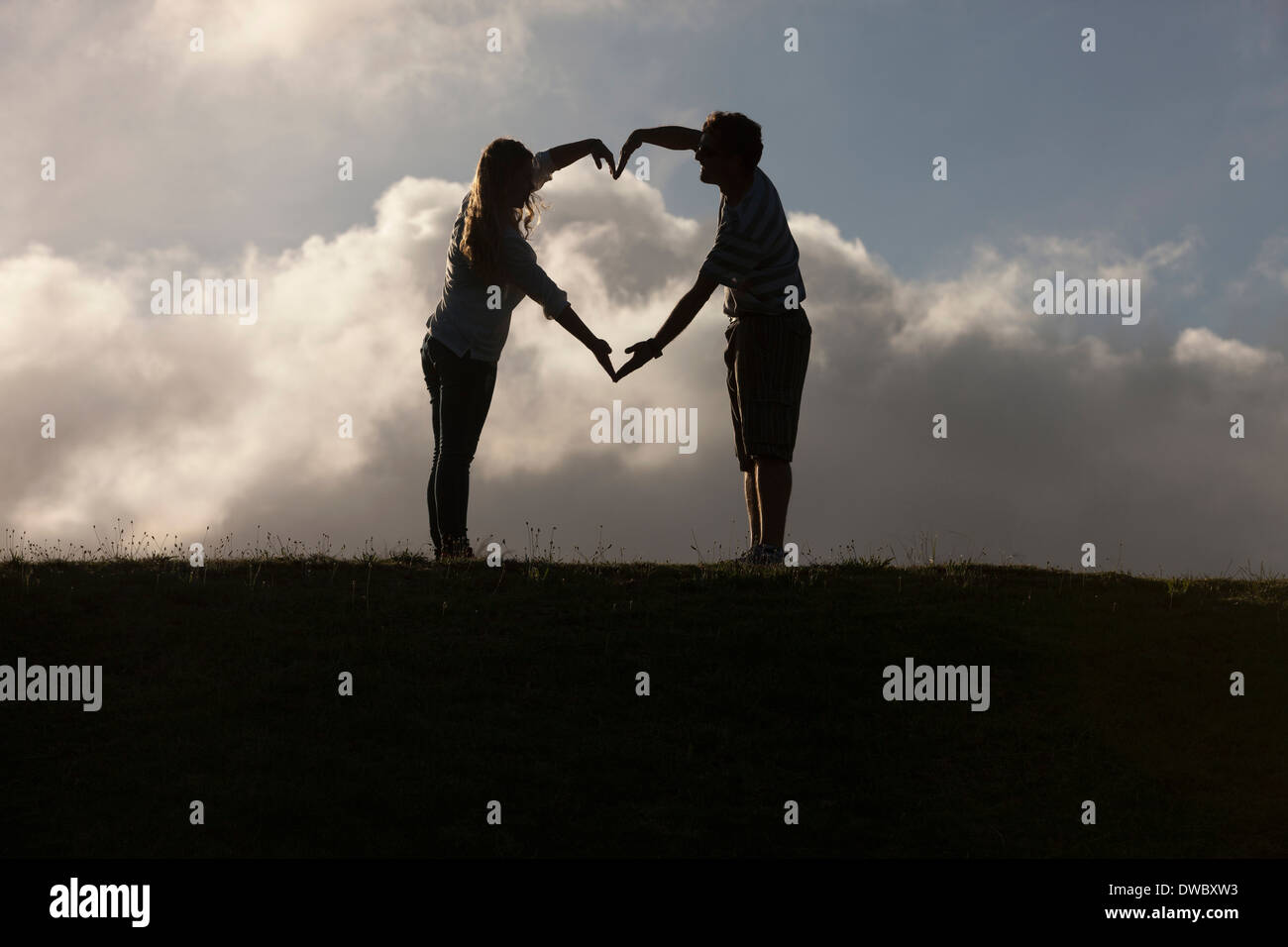 woman forming heart shape Stock Photo - Alamy
