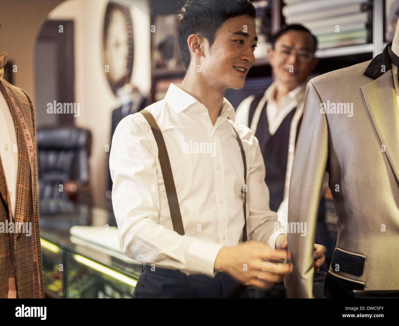 Father and son at work in family tailors shop Stock Photo - Alamy