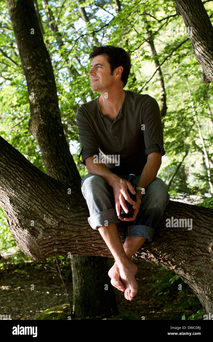 Sitting on tree trunk hi-res stock photography and images - Alamy