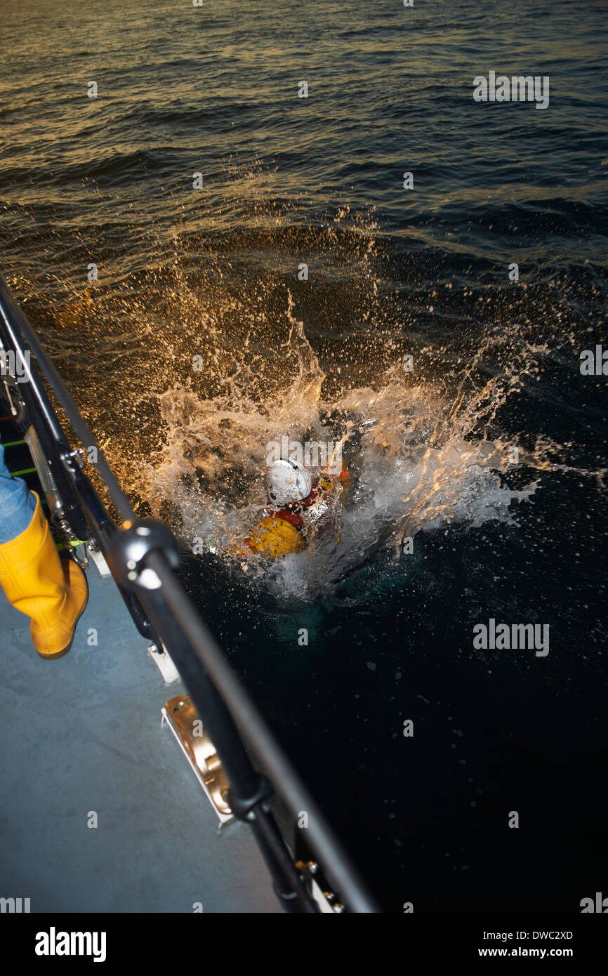 Lifeboat crew training with team member in sea Stock Photo - Alamy