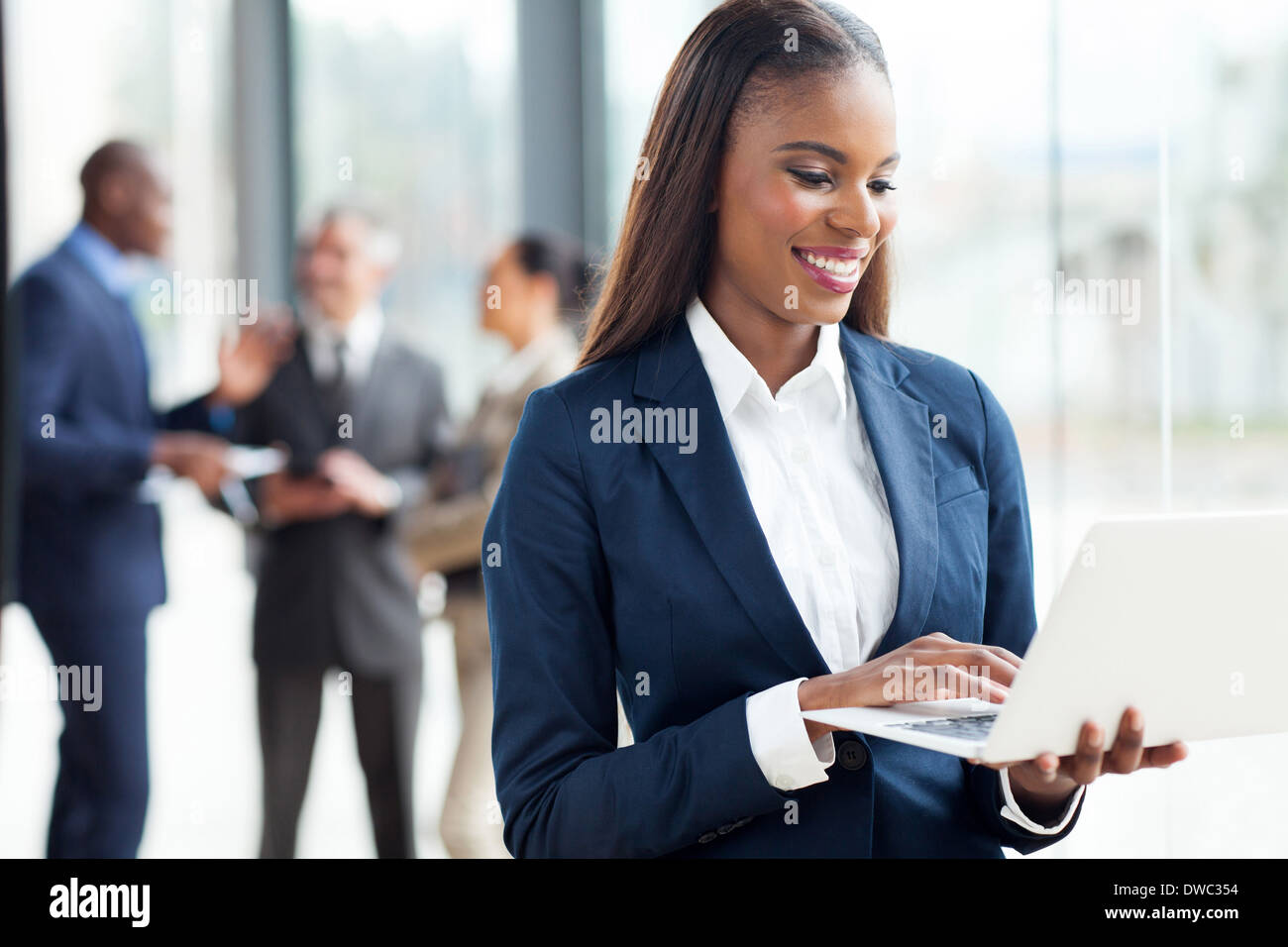 happy African businesswoman working on laptop computer Stock Photo - Alamy