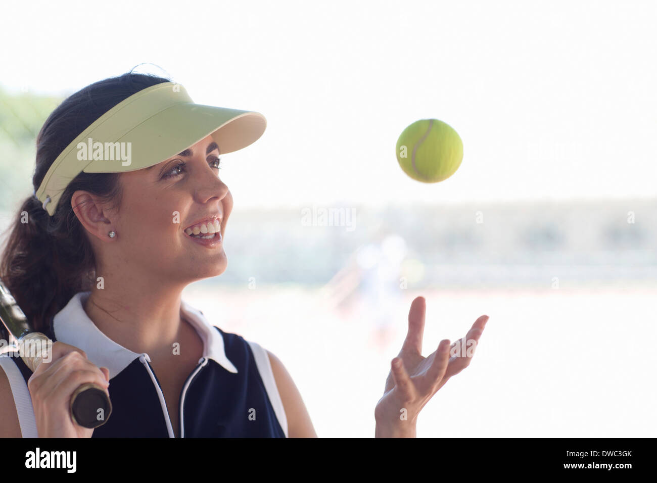 Tennis player tossing ball Stock Photo - Alamy