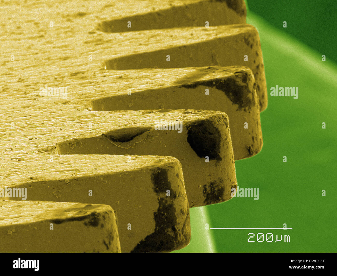 Coloured SEM of watch part Stock Photo - Alamy