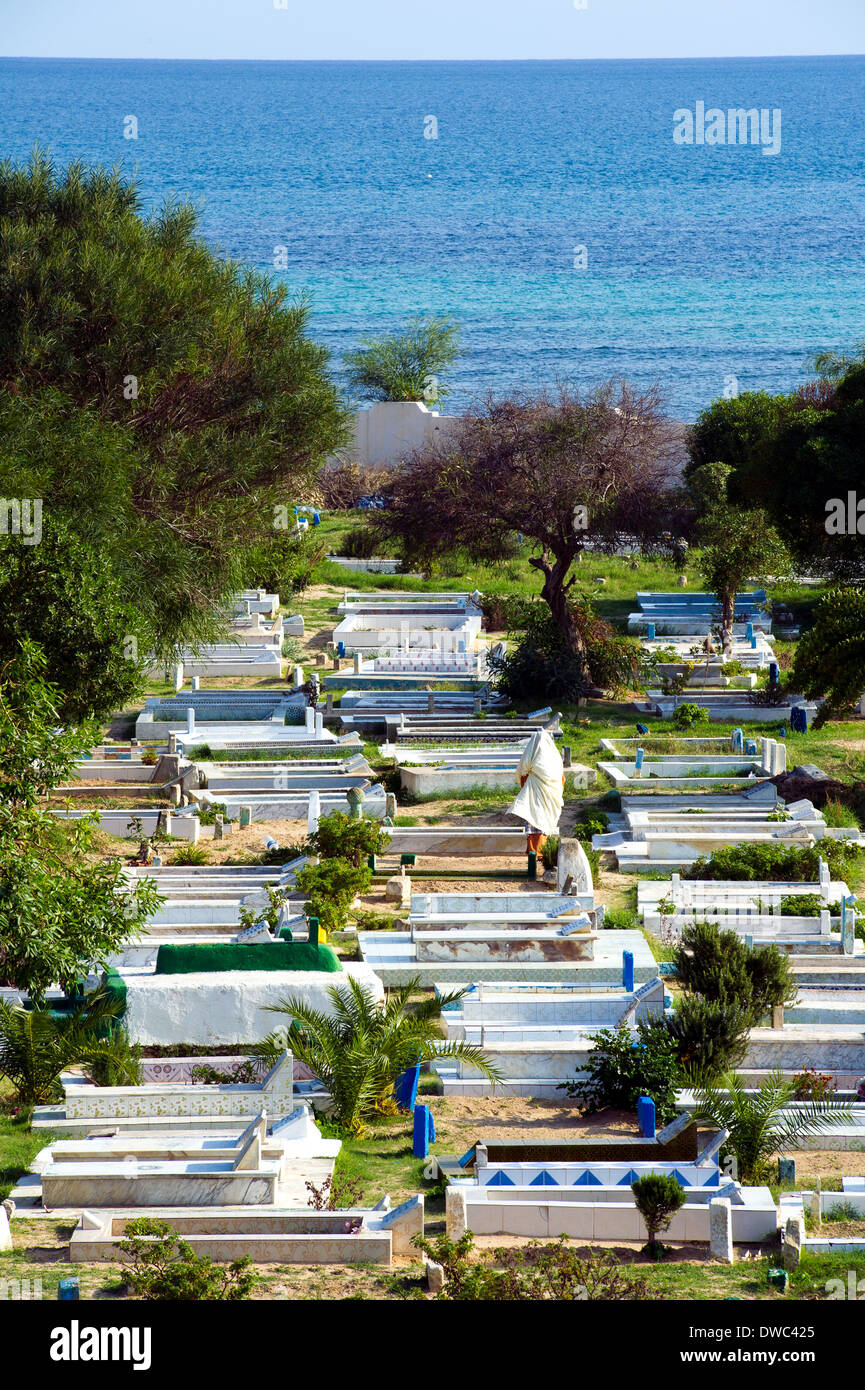 North Africa, Tunisia, Cape Bon, Hammamet. Woman in a Muslim cemetery ...