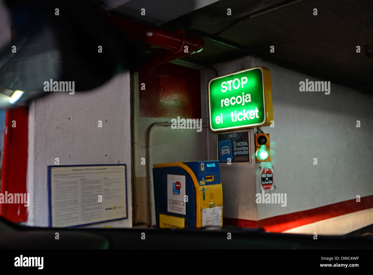 Sign at parking entrance reads Stop Pick Up Ticket in Spanish Stock ...