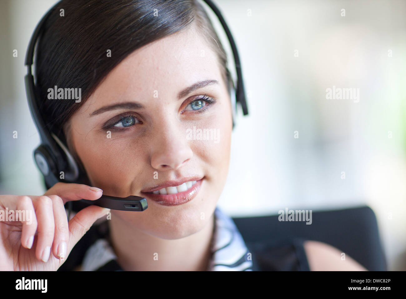 Young office worker talking on handset Stock Photo - Alamy