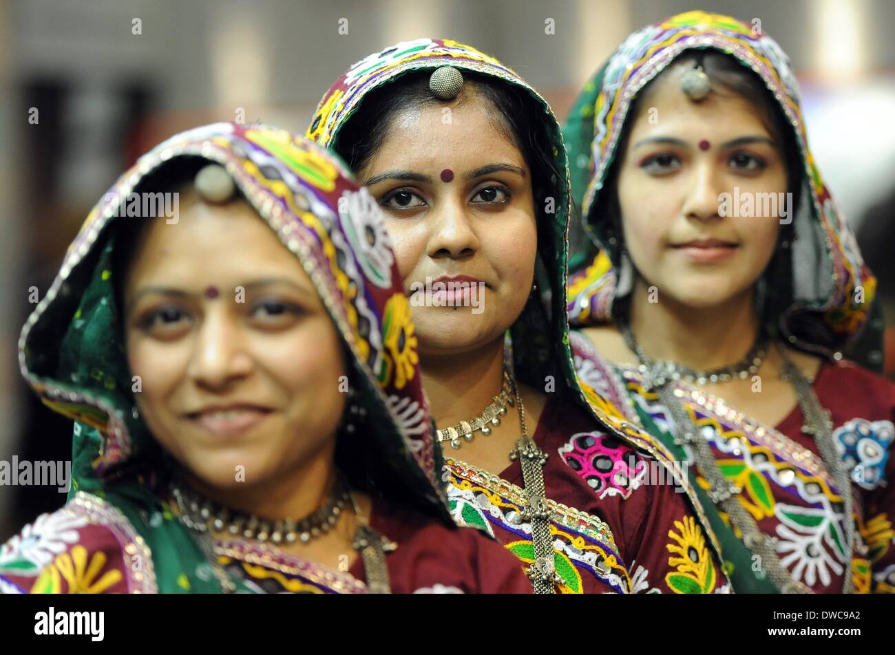 Women wear traditional costume at the booth of India during the ...