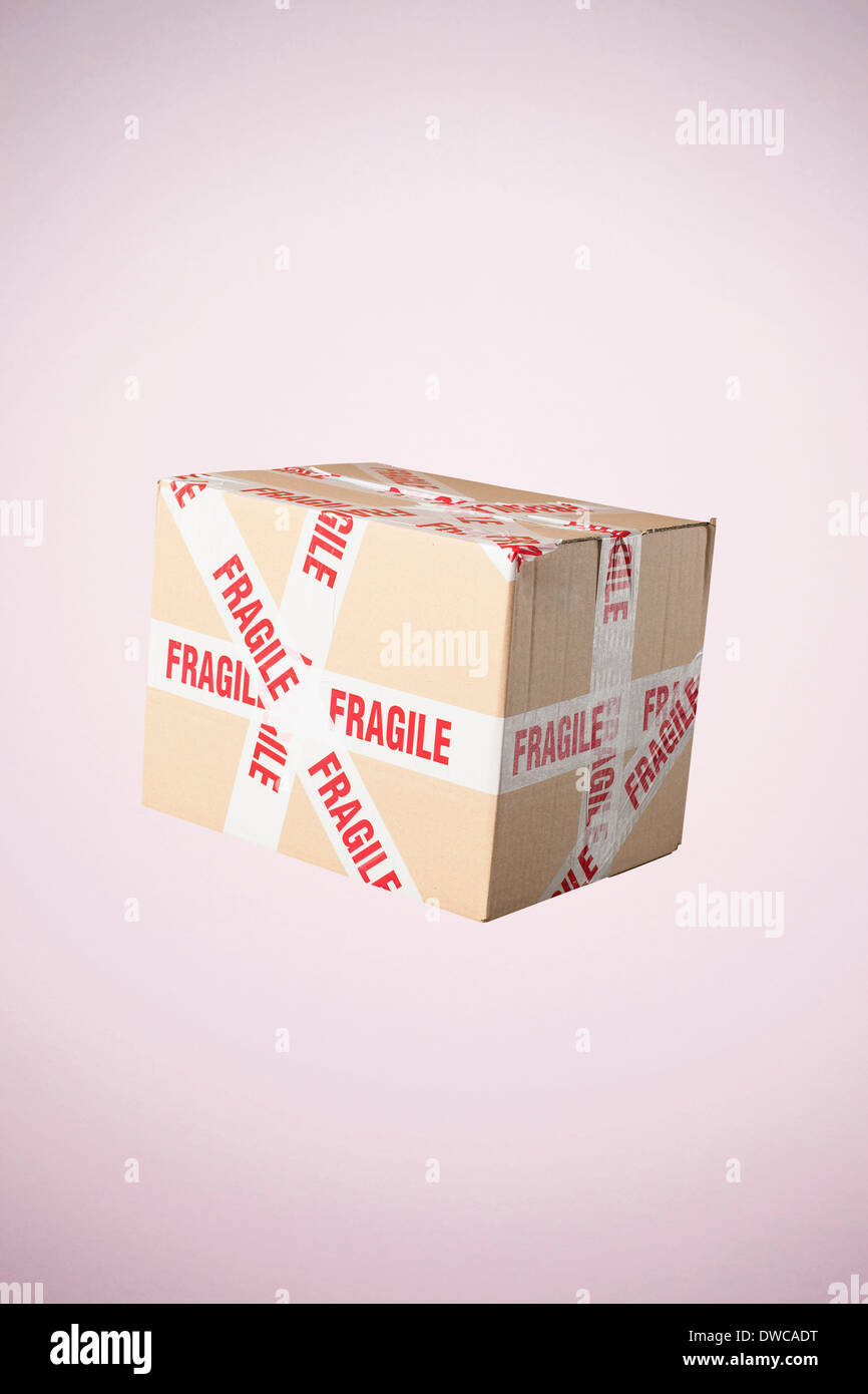 Studio shot of cardboard box marked fragile Stock Photo - Alamy