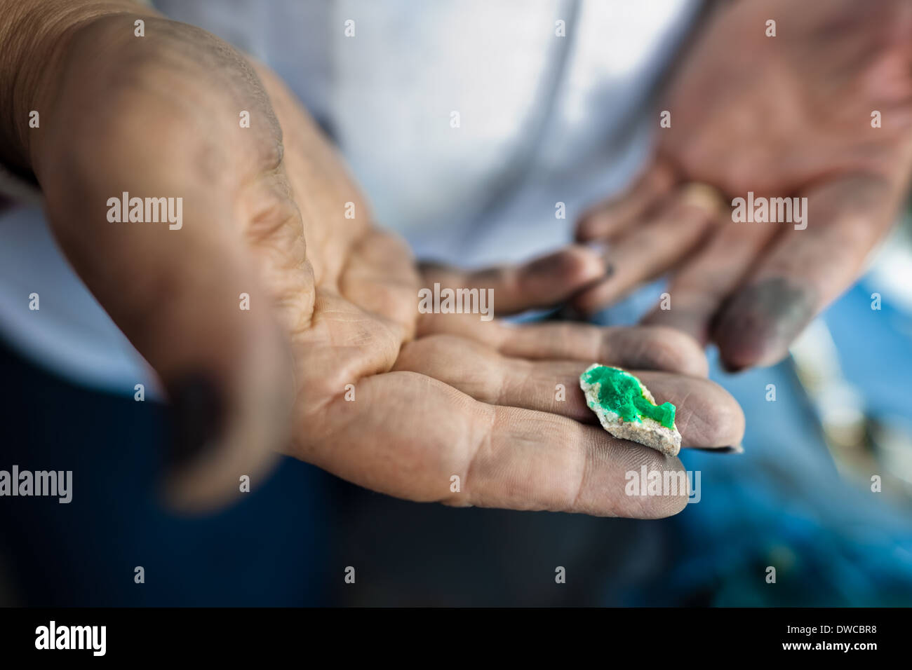 An emerald cutter shows a rough emerald before being processed in a ...