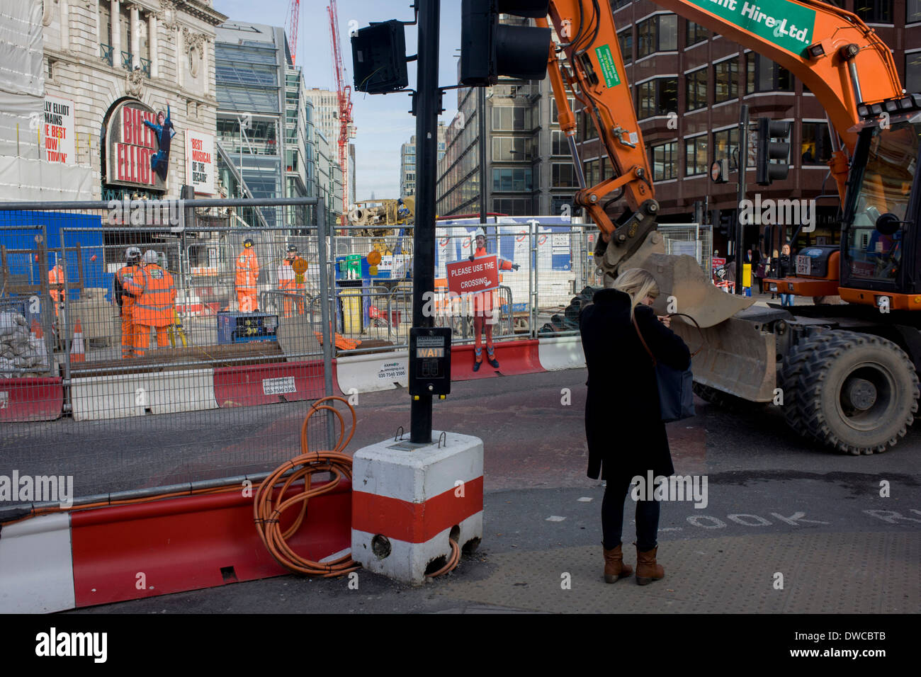 Digger drives past footpath disruption sign using illustration of TFL ...