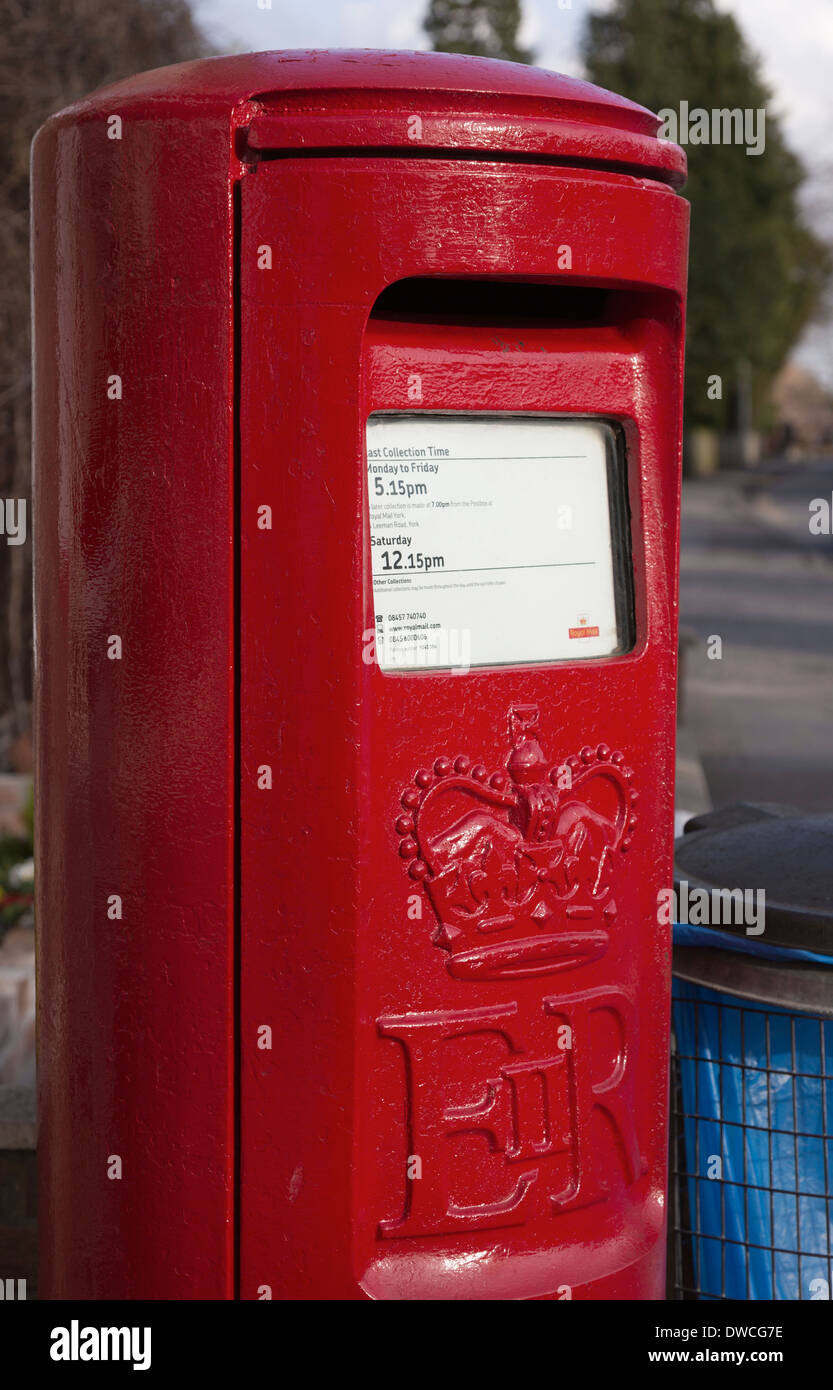 Red post box with collection times and location visible Stock Photo - Alamy