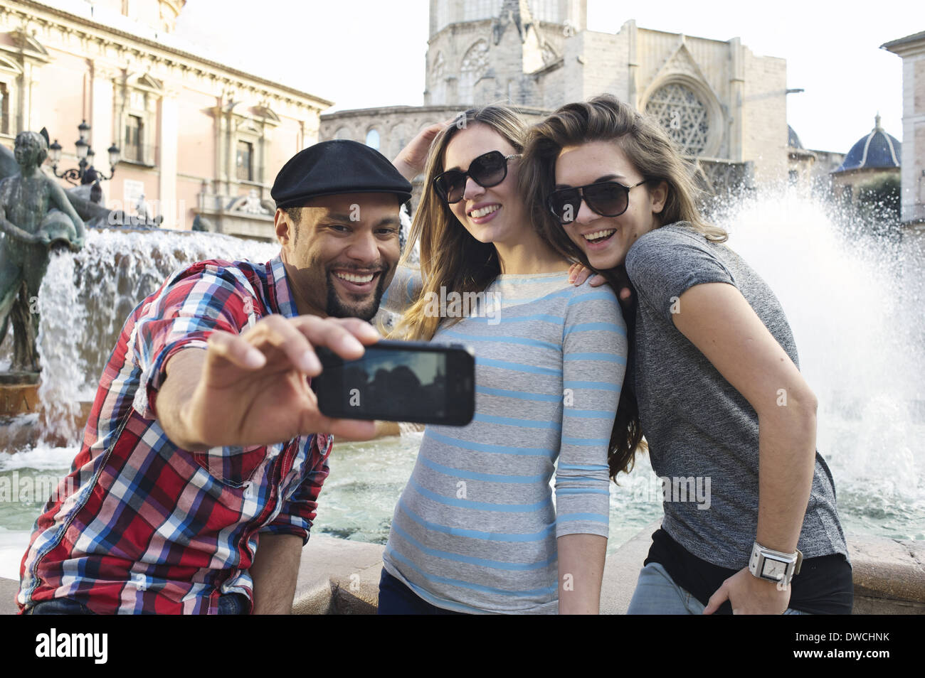 Tourist friends taking self portrait, Plaza de la Virgen, Valencia ...