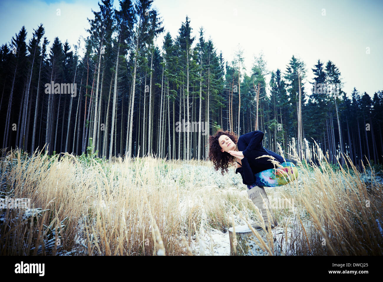 Mid adult woman practicing yoga moves in forest Stock Photo - Alamy