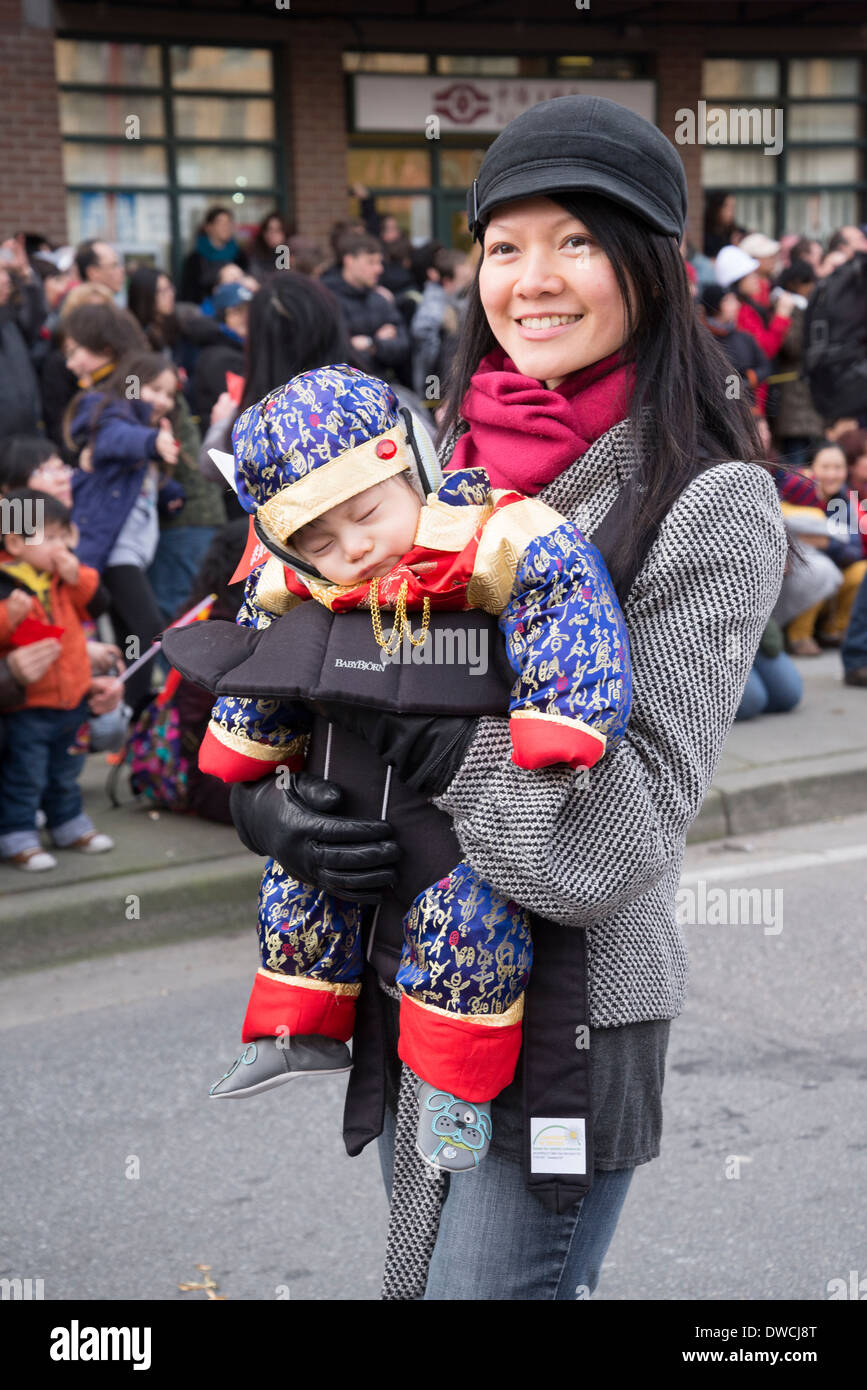 woman carrying sleeping child Stock Photo - Alamy