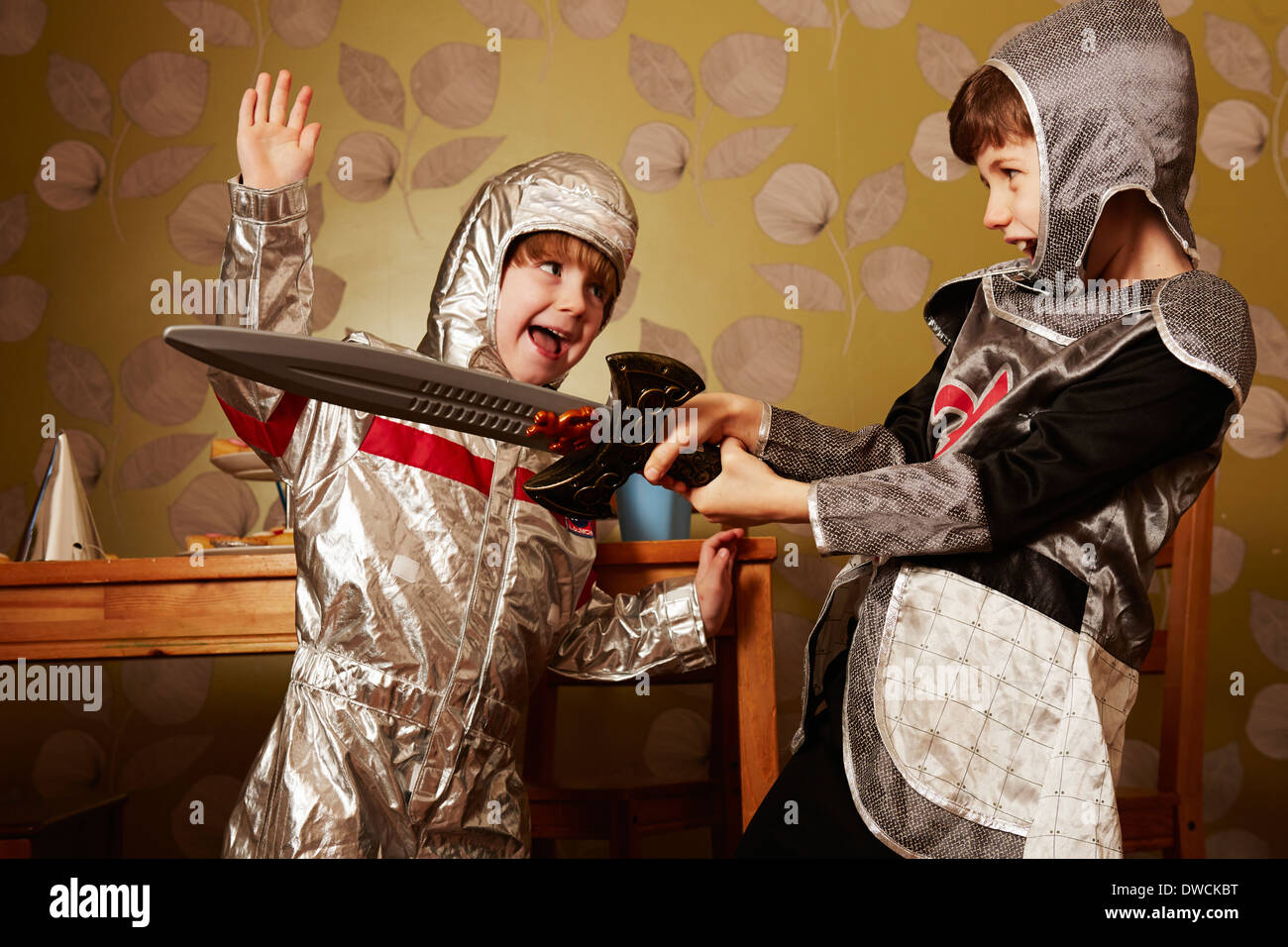Two boys dressed as knights playing with toy sword Stock Photo - Alamy