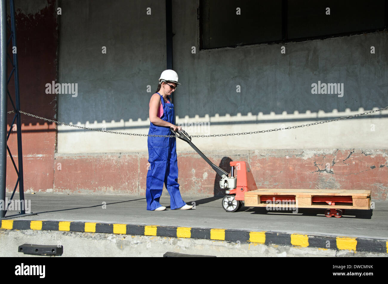 image of a working woman at the loading trolley Stock Photo - Alamy