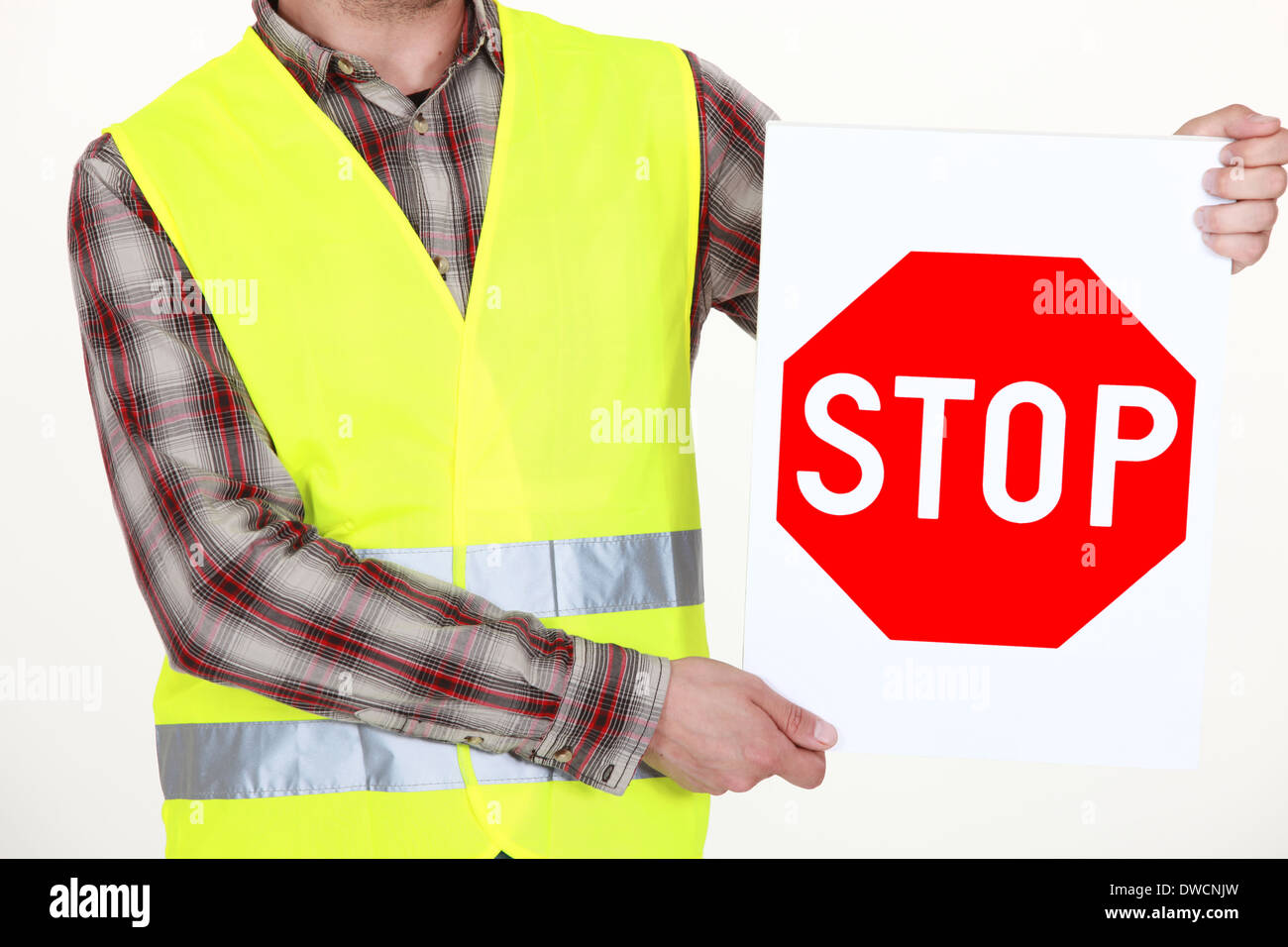 A cropped picture of a road worker holding a stop sign Stock Photo - Alamy