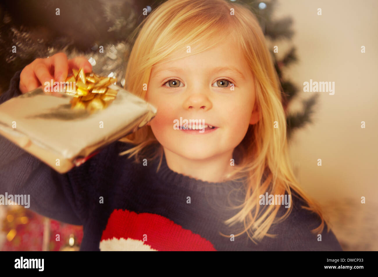 Child holding Christmas present Stock Photo - Alamy