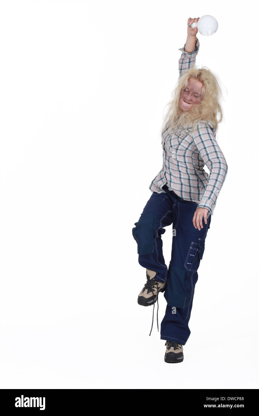 angry female electrician holding a bulb Stock Photo - Alamy