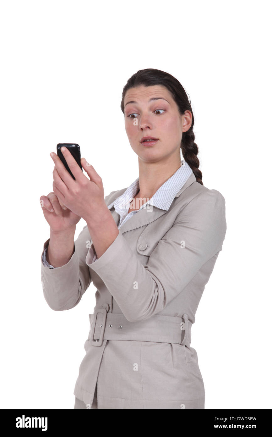 Woman shocked by text message Stock Photo - Alamy