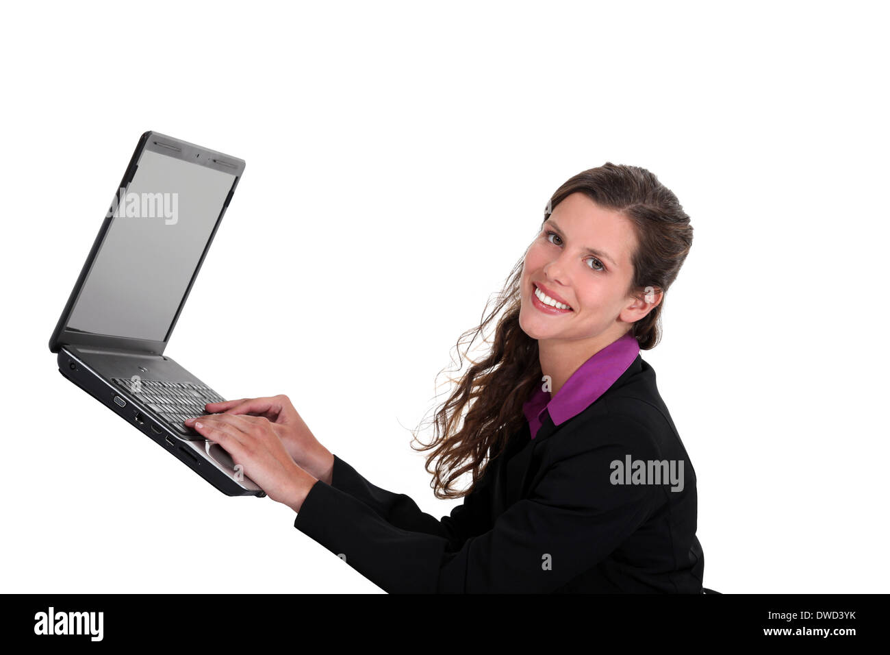 Woman typing on a laptop in mid-air Stock Photo - Alamy