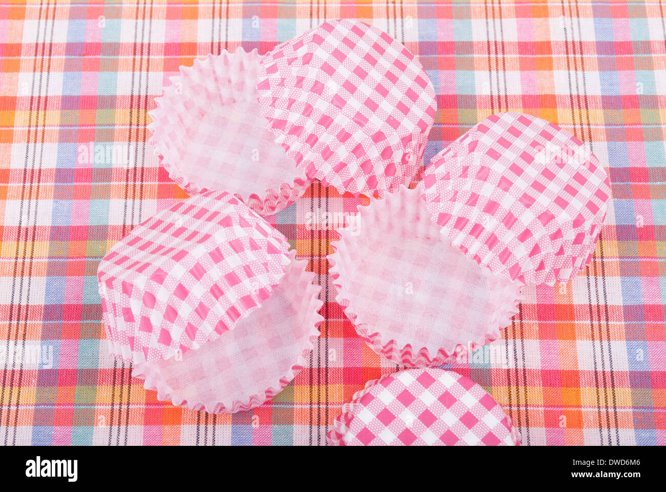 Paper molds for baking muffins on the table Stock Photo - Alamy