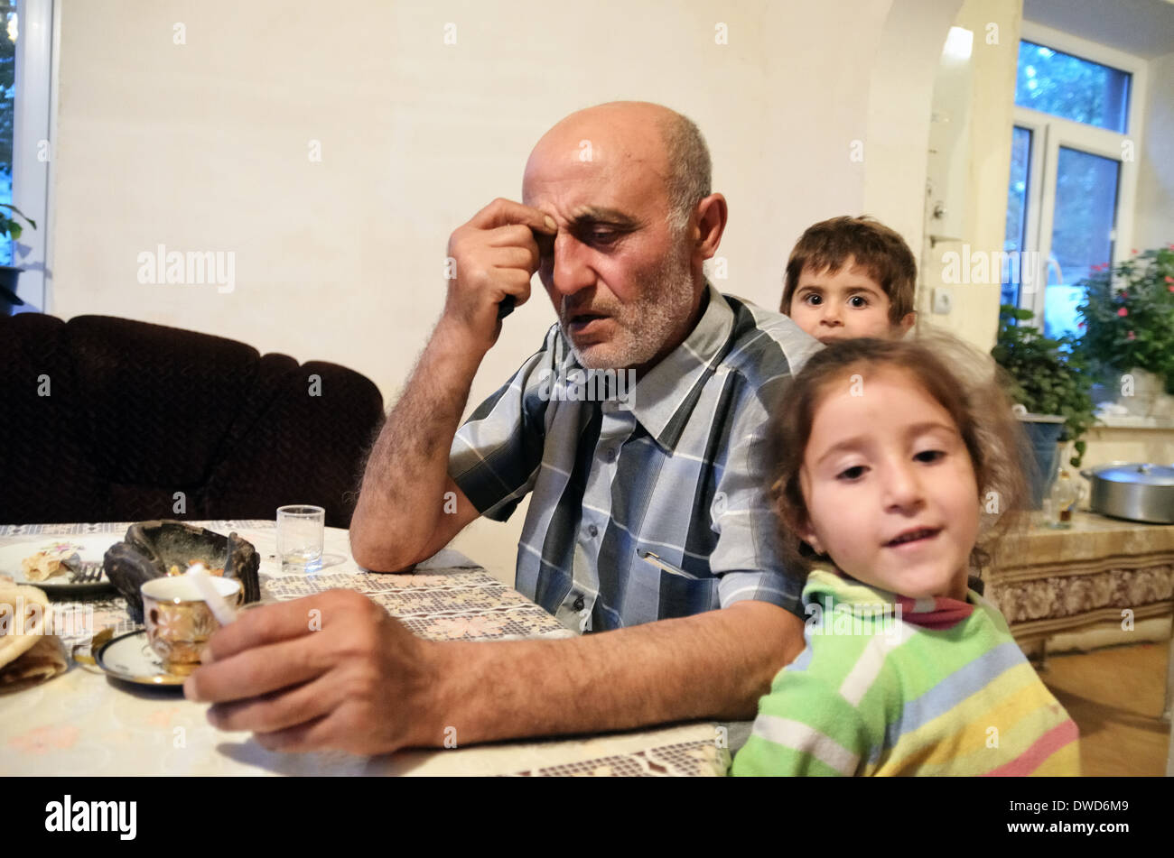 Senior Armenian man with his grand-daughters in traditional Armenian ...