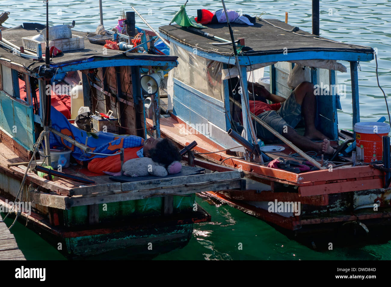 Fishermen sleeping on their boats along the pier in Ban Ao Yai, Koh ...