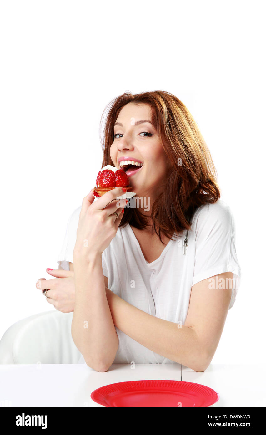 Beautiful woman eating fresh strawberry cake isolated on a white ...