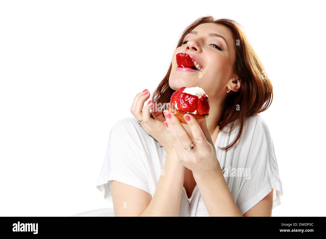 Charming woman eating fresh strawberry cake isolated on a white ...