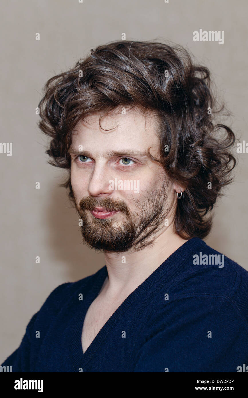 Dramatic portrait of the poet with curly hair when thinking shot ...