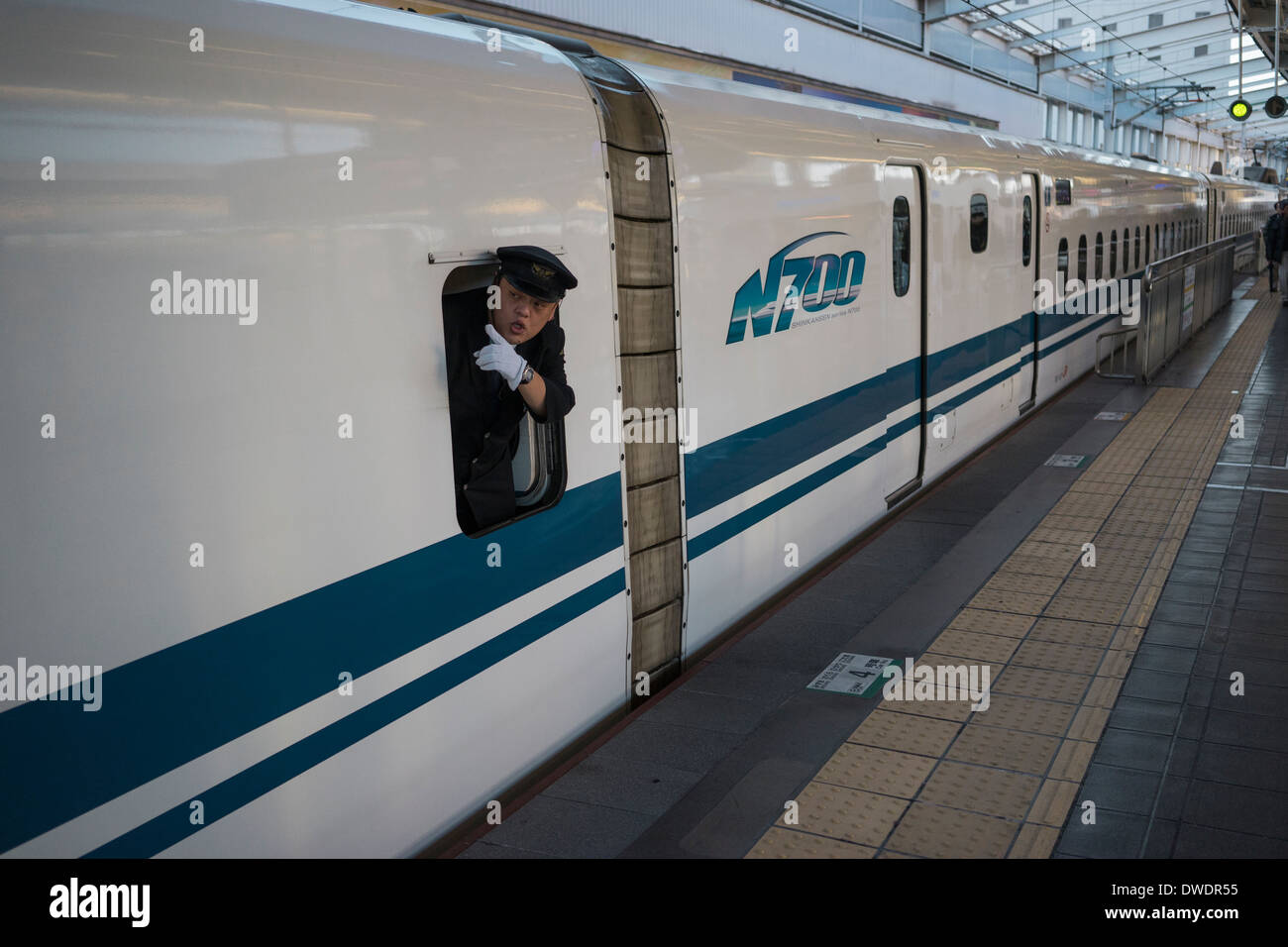 Japan, train conductor checking platform in a N700 Nozomi Shinkansen ...