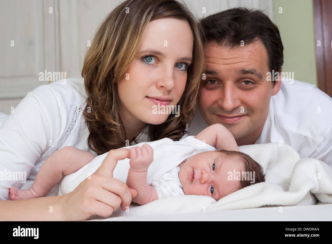 Portrait of parents with newborn baby girl Stock Photo - Alamy