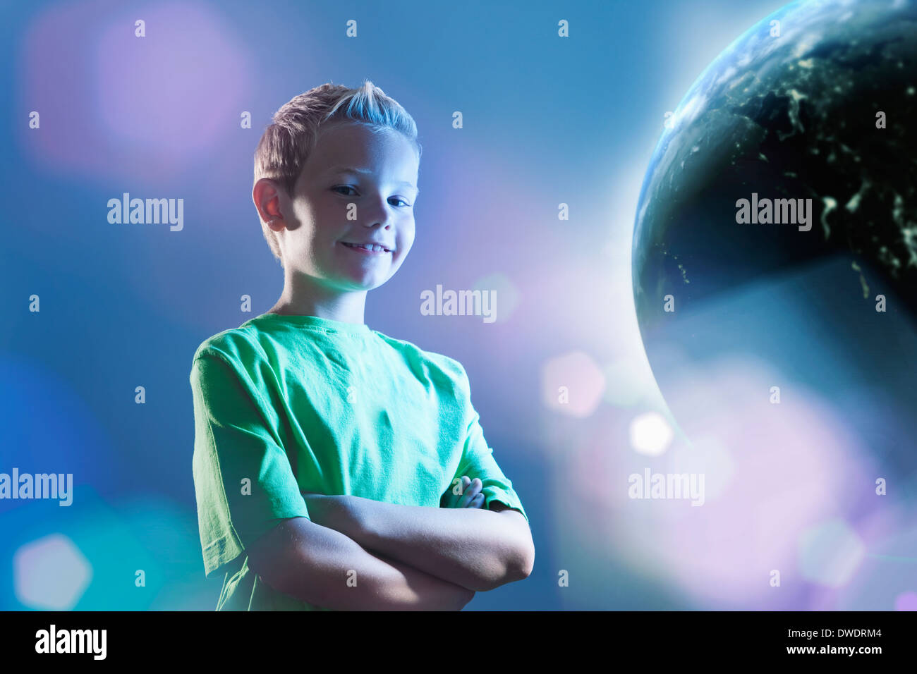 Smiling young boy watching earth Stock Photo - Alamy