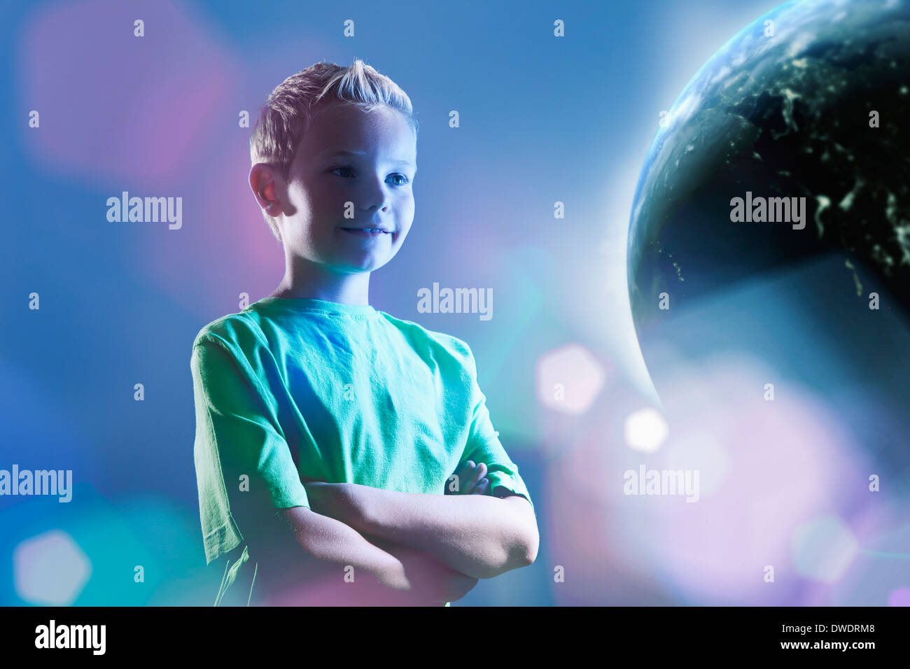 Smiling young boy watching earth Stock Photo - Alamy