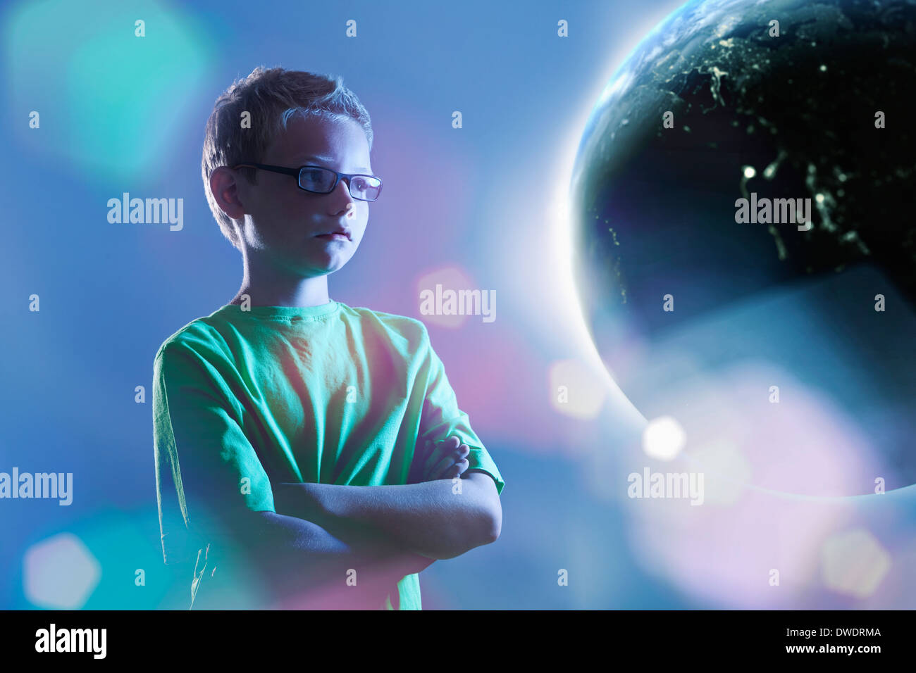 Young boy watching earth Stock Photo - Alamy