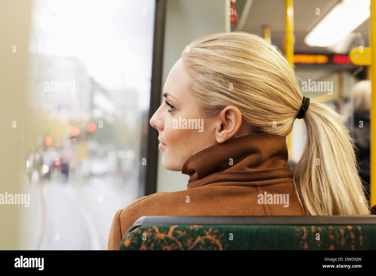 Rear view of woman looking out through bus window Stock Photo - Alamy