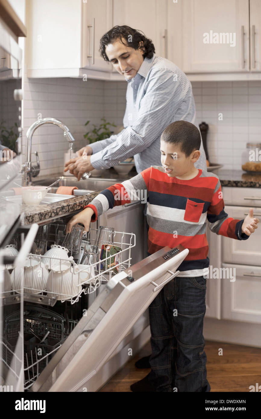 Boy helping father in kitchen Stock Photo - Alamy