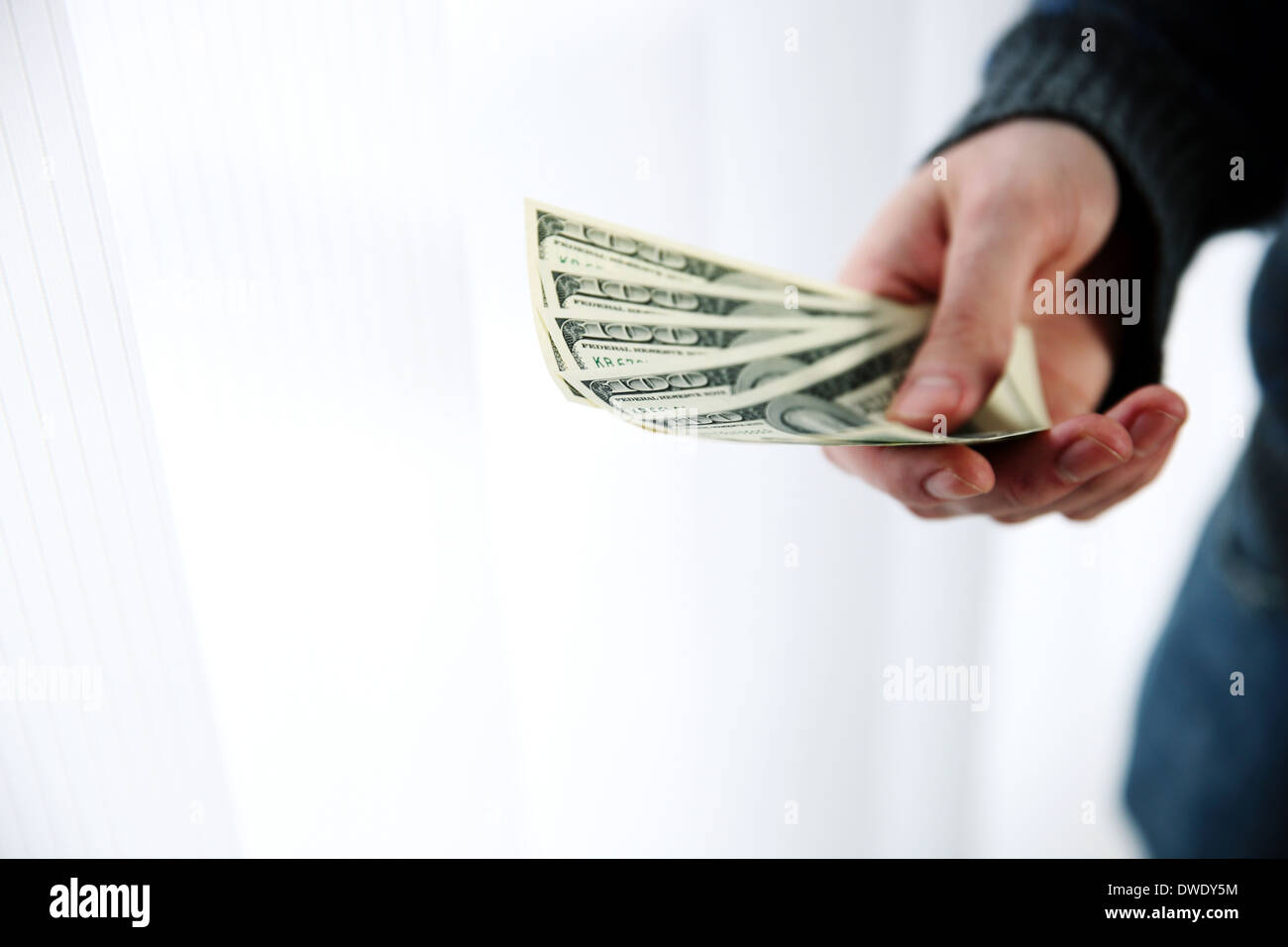 Closeup portrait of a male hand giving money Stock Photo - Alamy