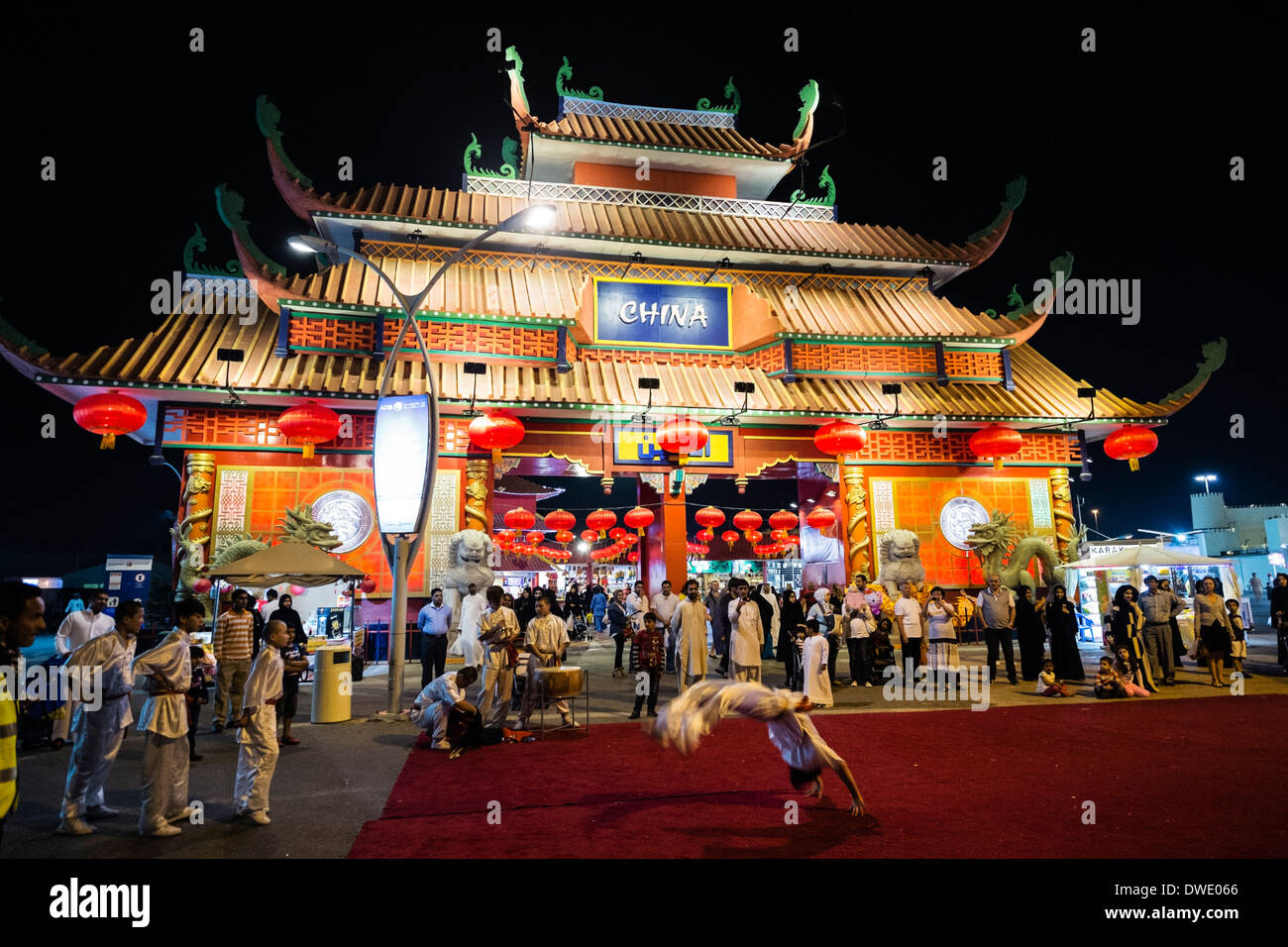 Acrobats perform outside China Pavilion at Global Village tourist ...