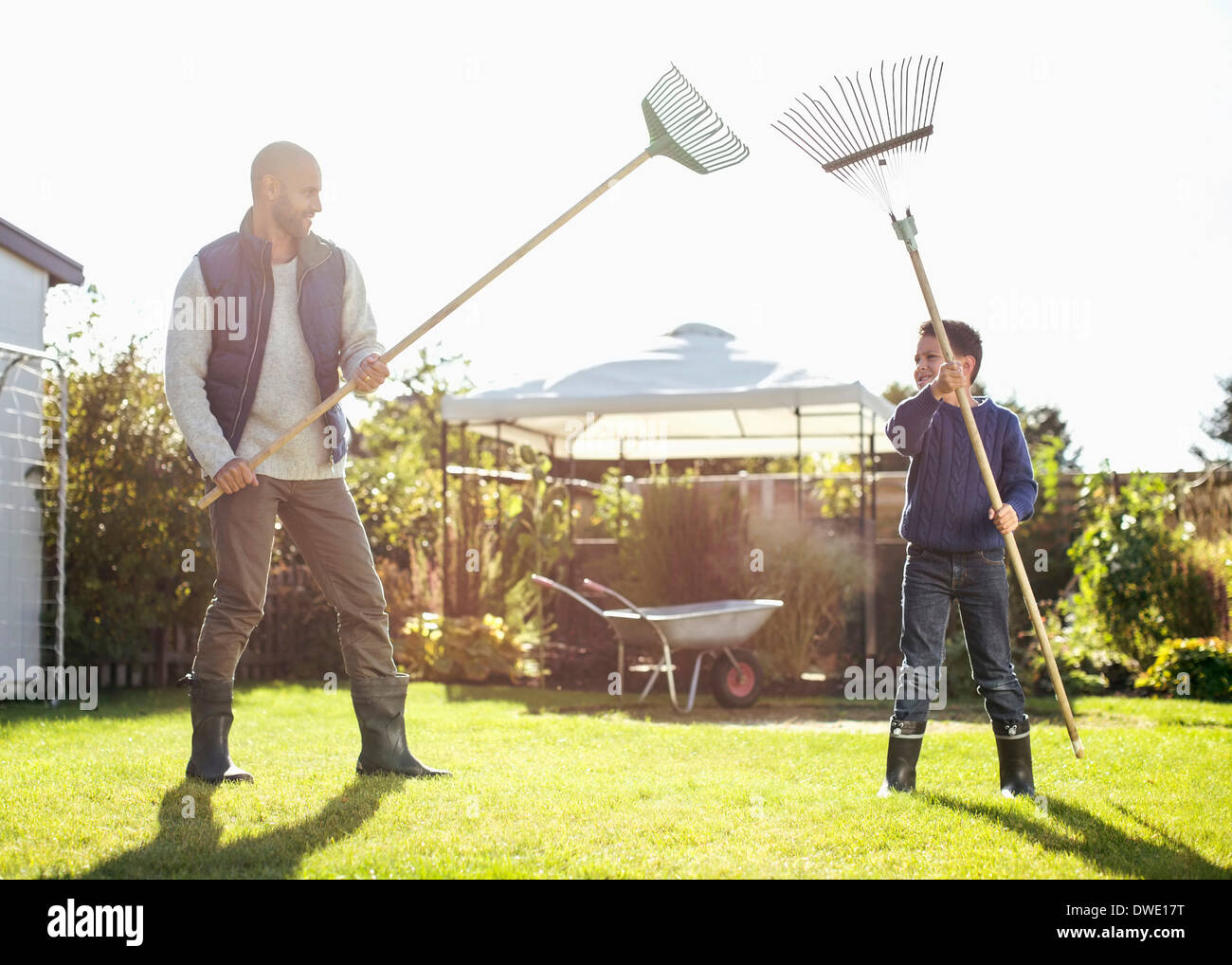 Boys outside home with rakes hi-res stock photography and images - Alamy