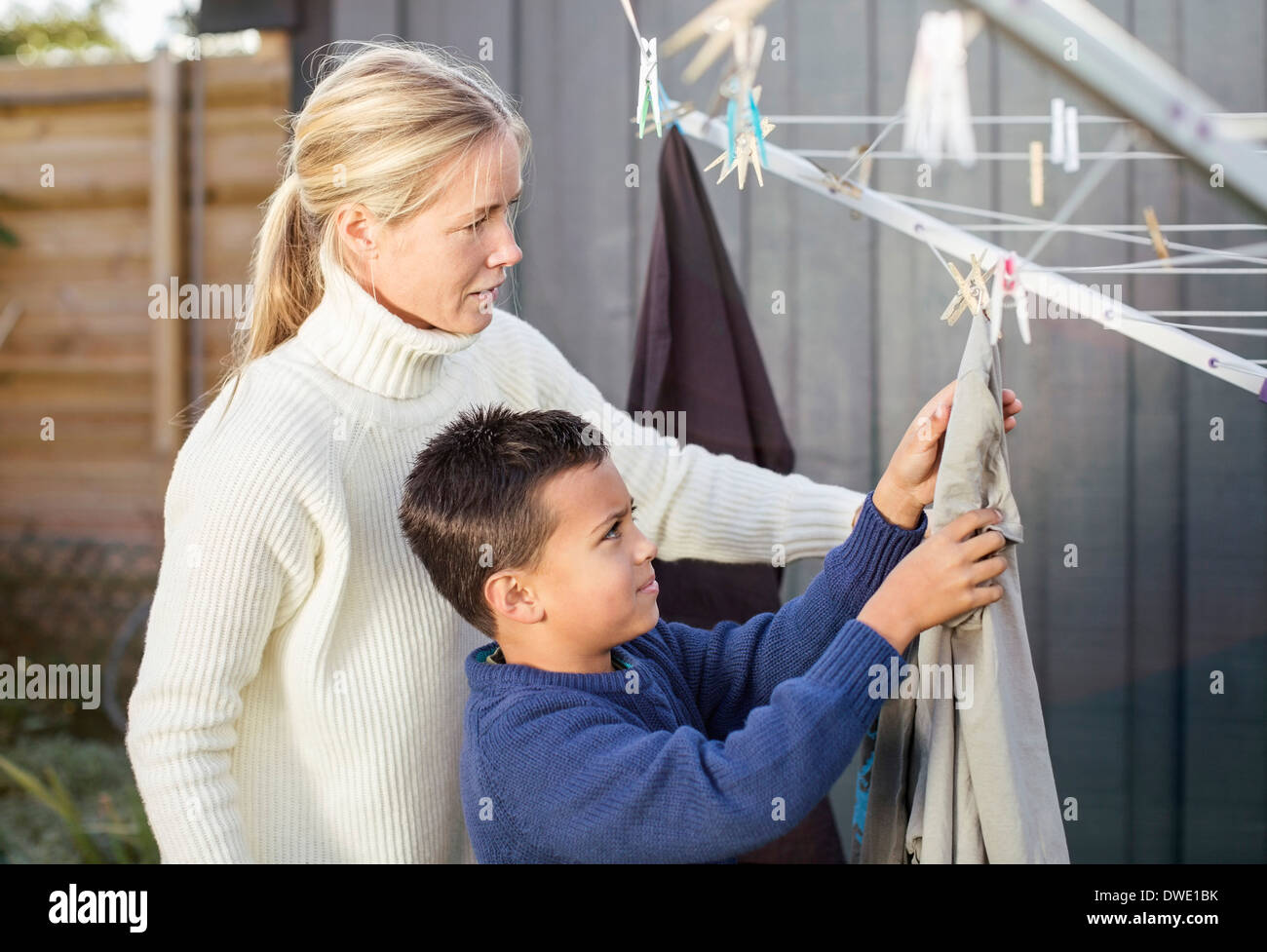 Mother and son doing laundry at yard Stock Photo - Alamy