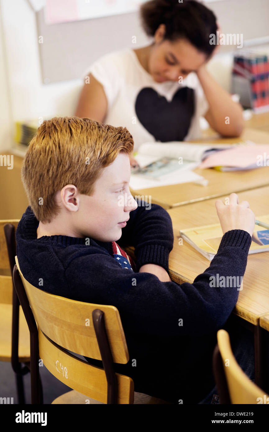 School students sitting at desk in classroom Stock Photo - Alamy